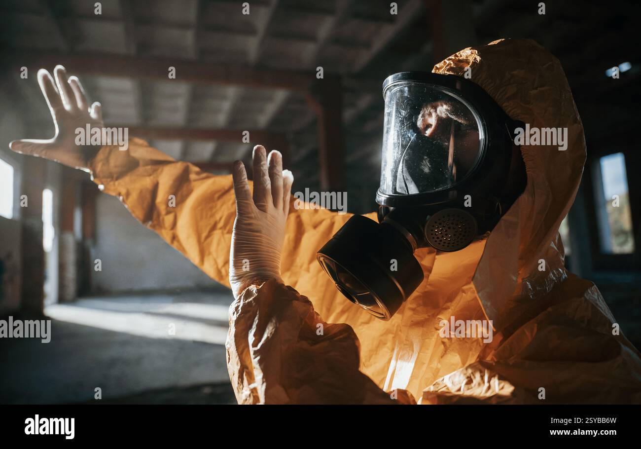 Light from nuclear explosion. Man dressed in chemical protection suit ...