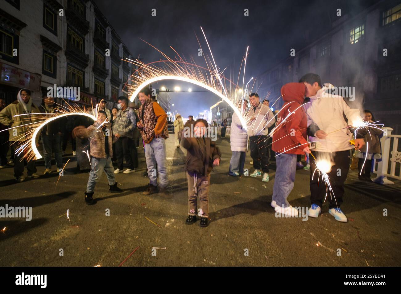 Lhasa,China.27th February 2025. Children set off fireworks to celebrate ...