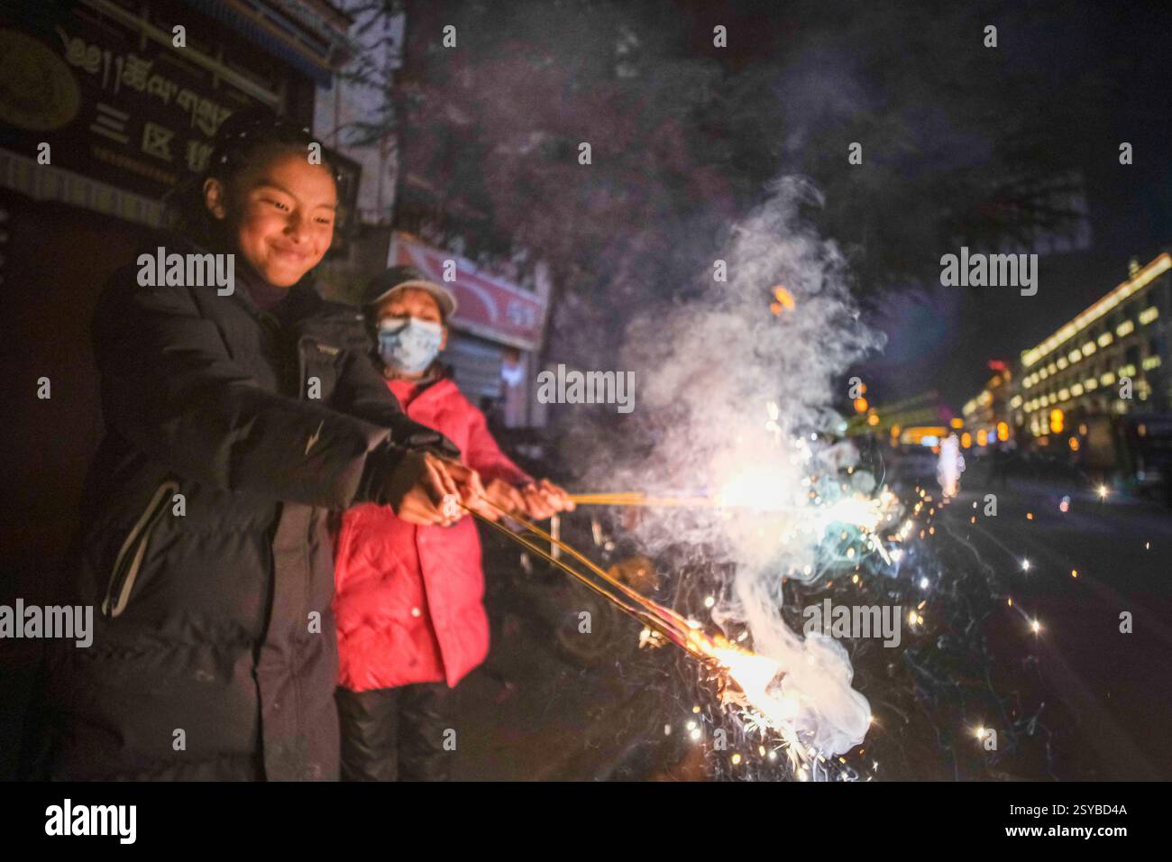 Lhasa,China.27th February 2025. Children set off fireworks to celebrate ...