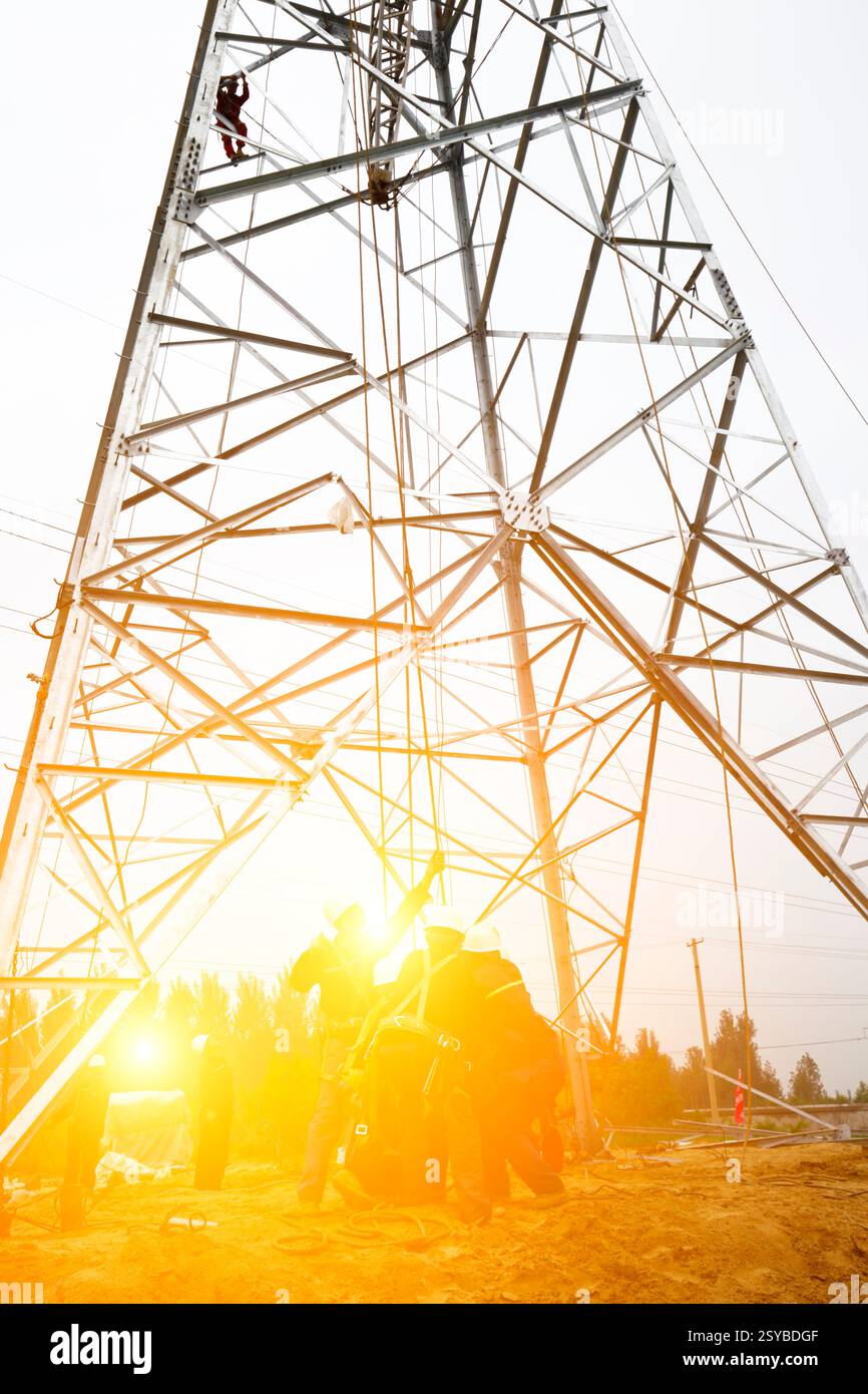 The workers of the pylon Stock Photo - Alamy