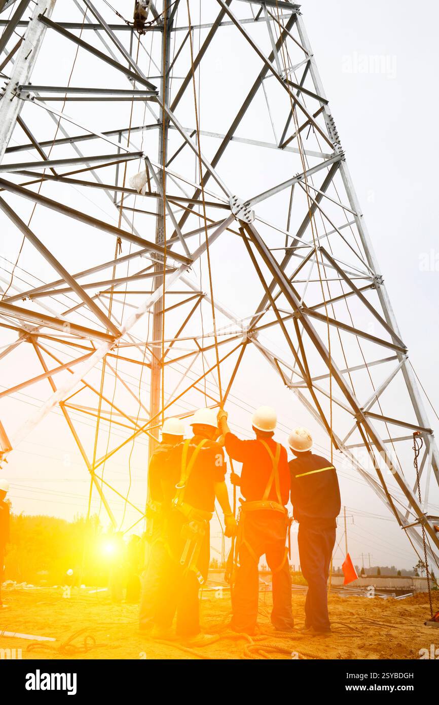 The workers of the pylon Stock Photo - Alamy