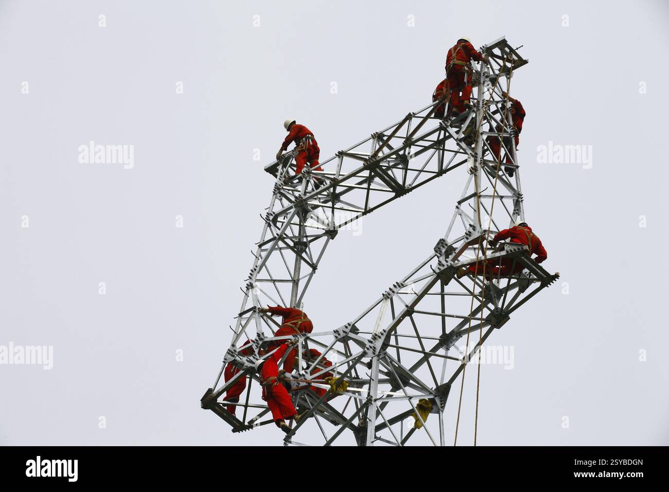 The workers of the pylon Stock Photo - Alamy