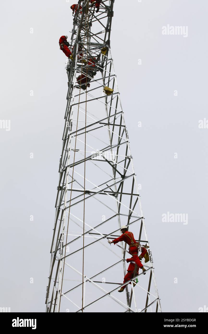 The workers of the pylon Stock Photo - Alamy
