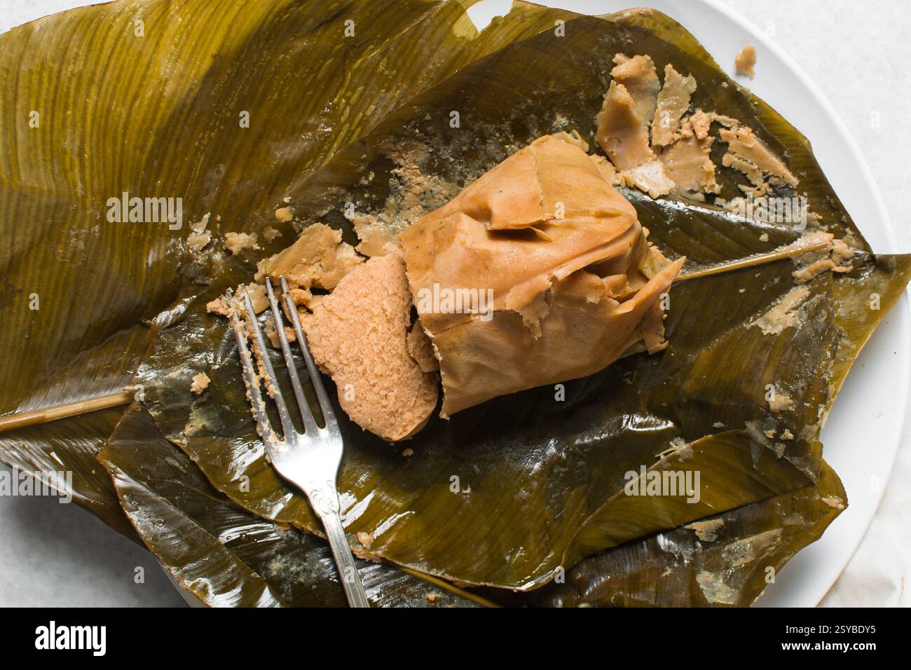 Overhead of moi moi in leaf on a plate, top view of nigerian bean ...
