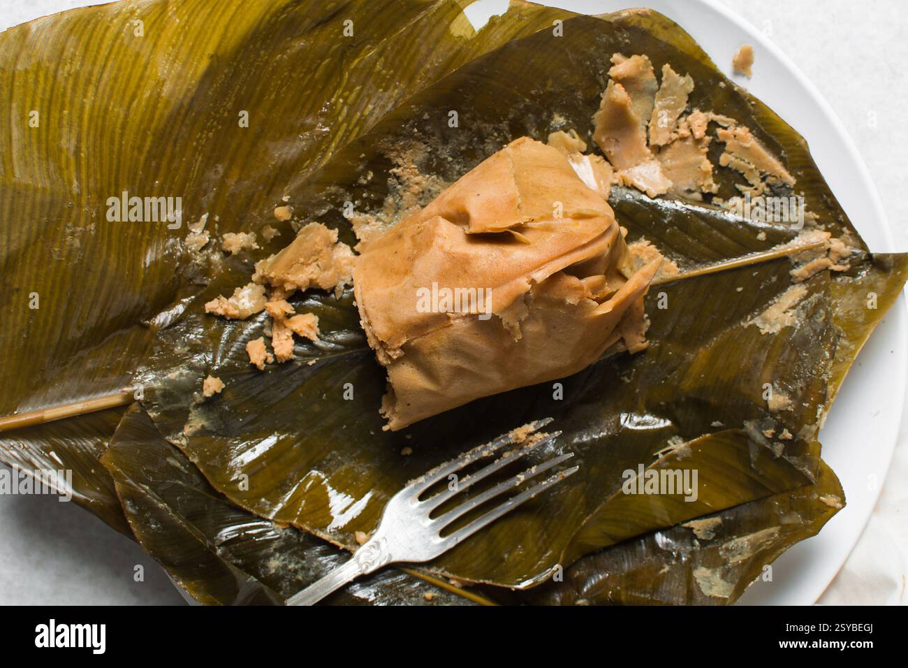 Overhead of moi moi in leaf on a plate, top view of nigerian bean ...