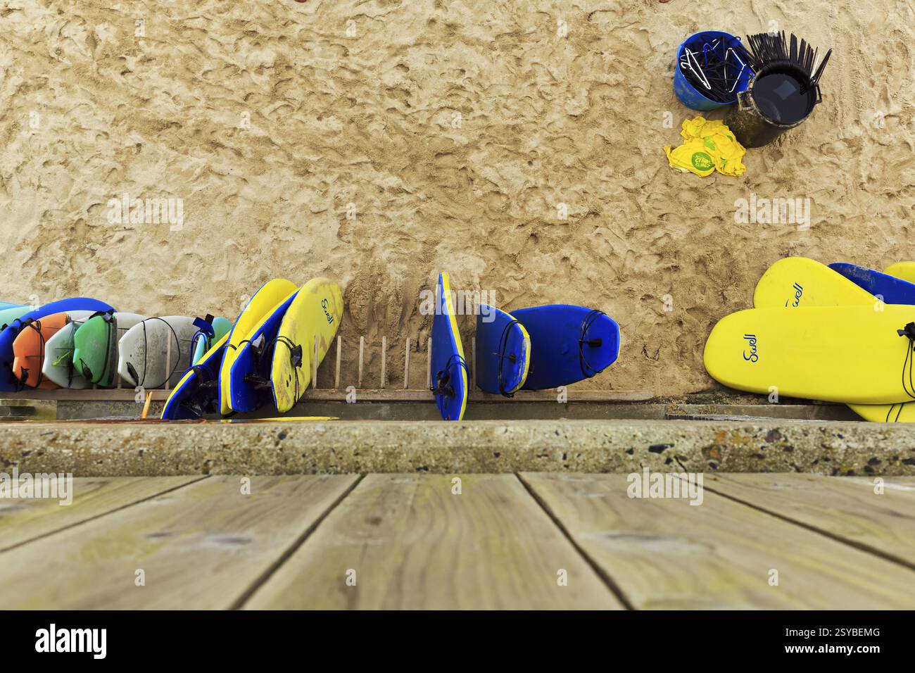 Surfboards leaning against a wall on the beach, surf school, view from ...