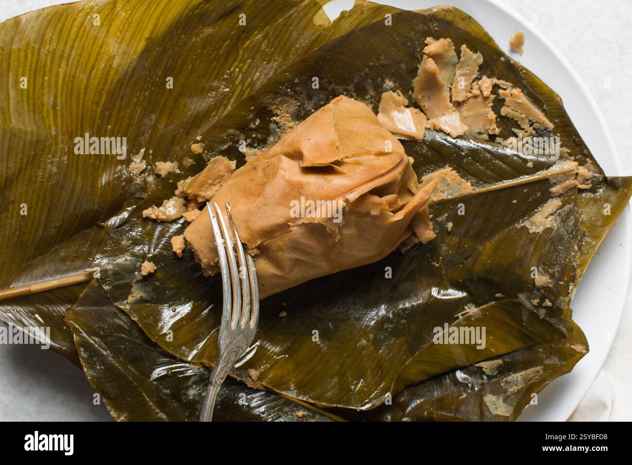 Overhead of moi moi in leaf on a plate, top view of nigerian bean ...