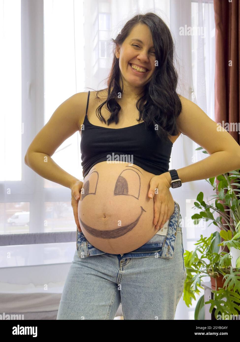 Pregnant Woman with Smiley Face Belly Art Stock Photo - Alamy