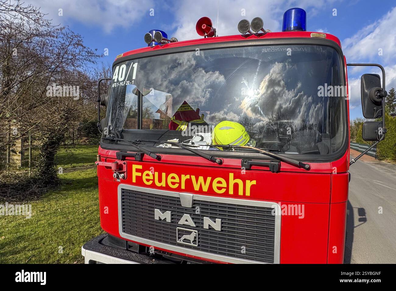 Front of red fire engine MAN truck with yellow lettering fire brigade ...