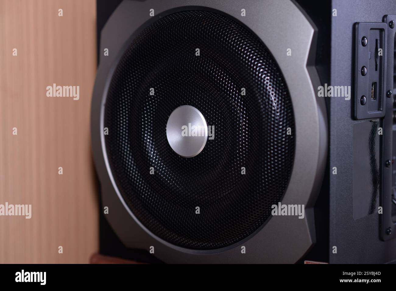 Close-up view of a black speaker with control panel and audio ...