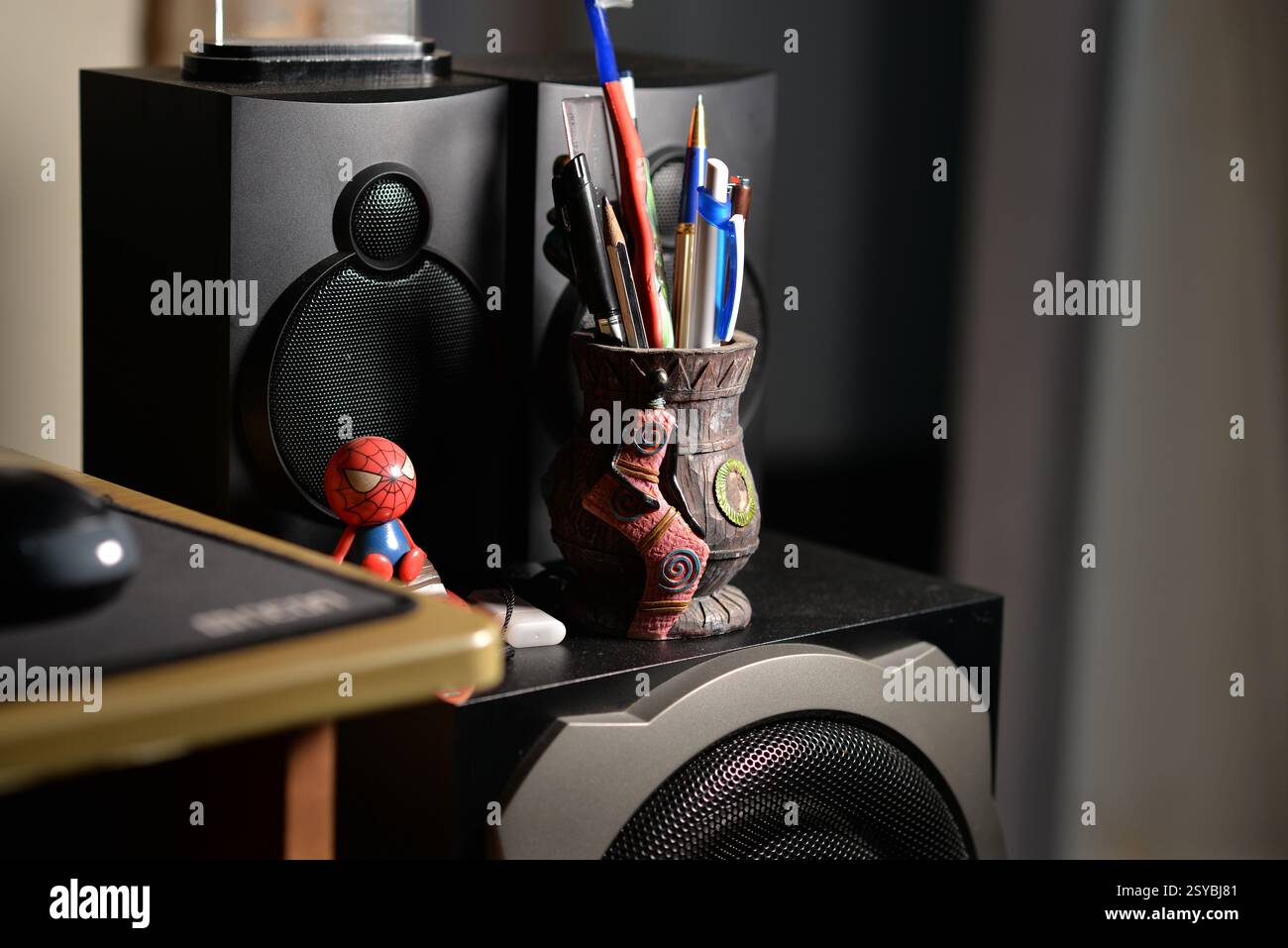 A cozy desktop workspace setup with speakers, a pen holder, and a ...