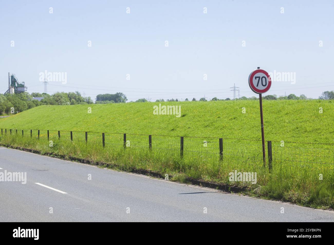 Traffic sign Speed limit 70 km/h on a country road with dyke, Leer ...