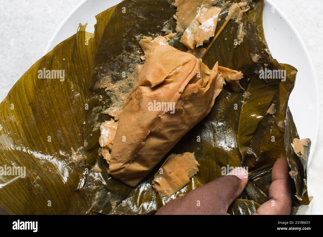 Overhead of moi moi in leaf on a plate, top view of nigerian bean ...