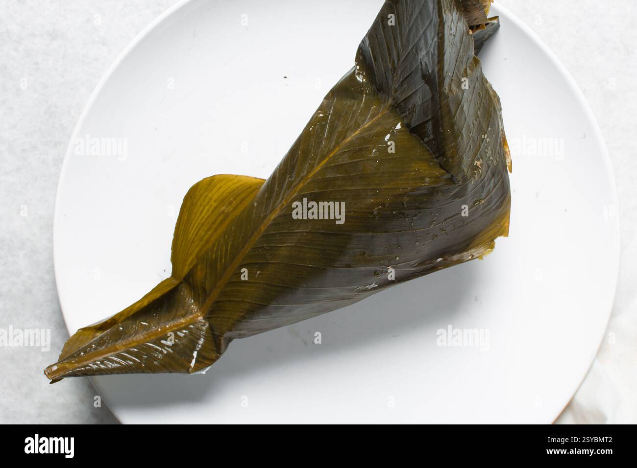 Overhead of moi moi in leaf on a plate, top view of nigerian bean ...