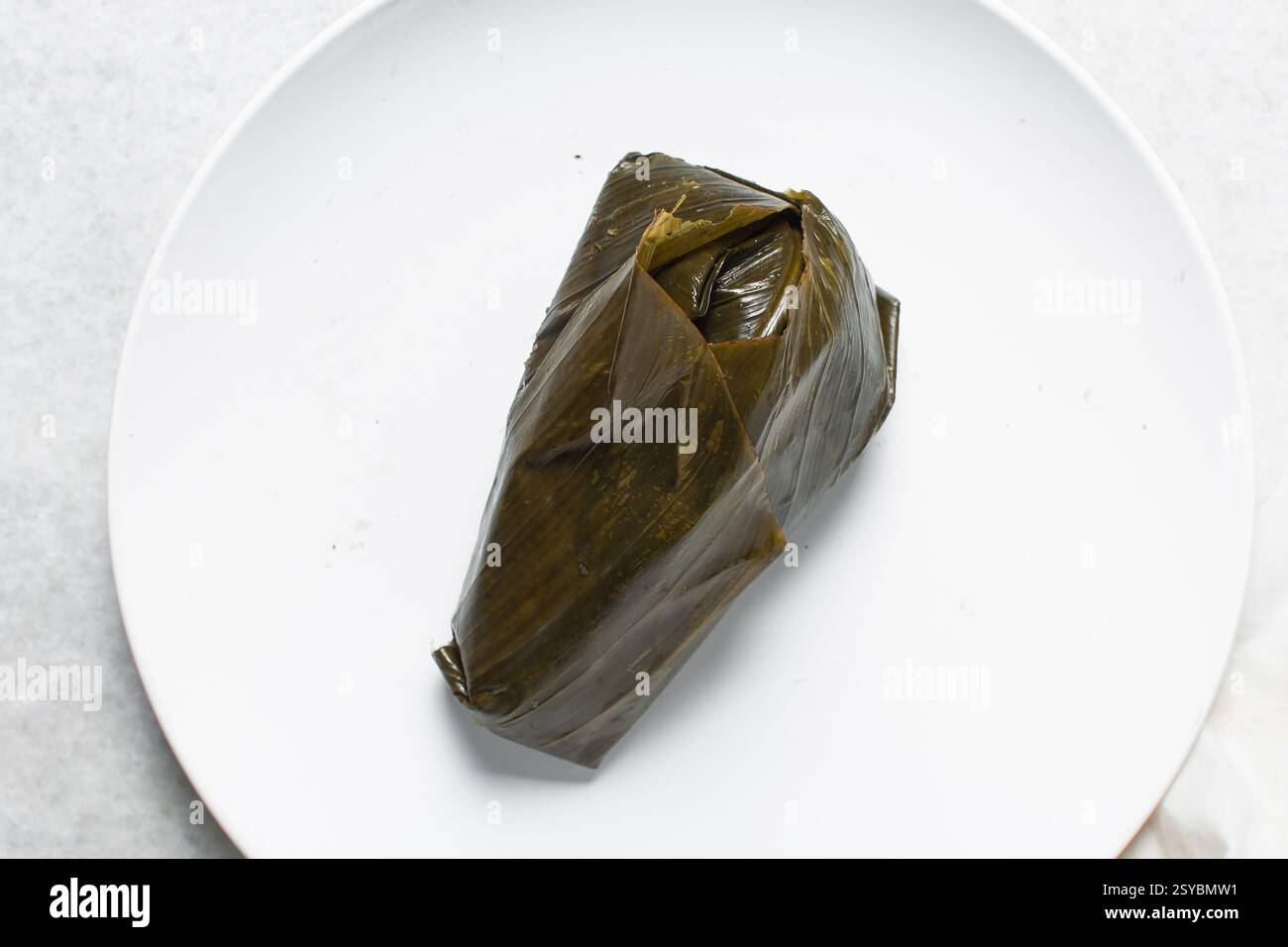 Overhead of moi moi in leaf on a plate, top view of nigerian bean ...