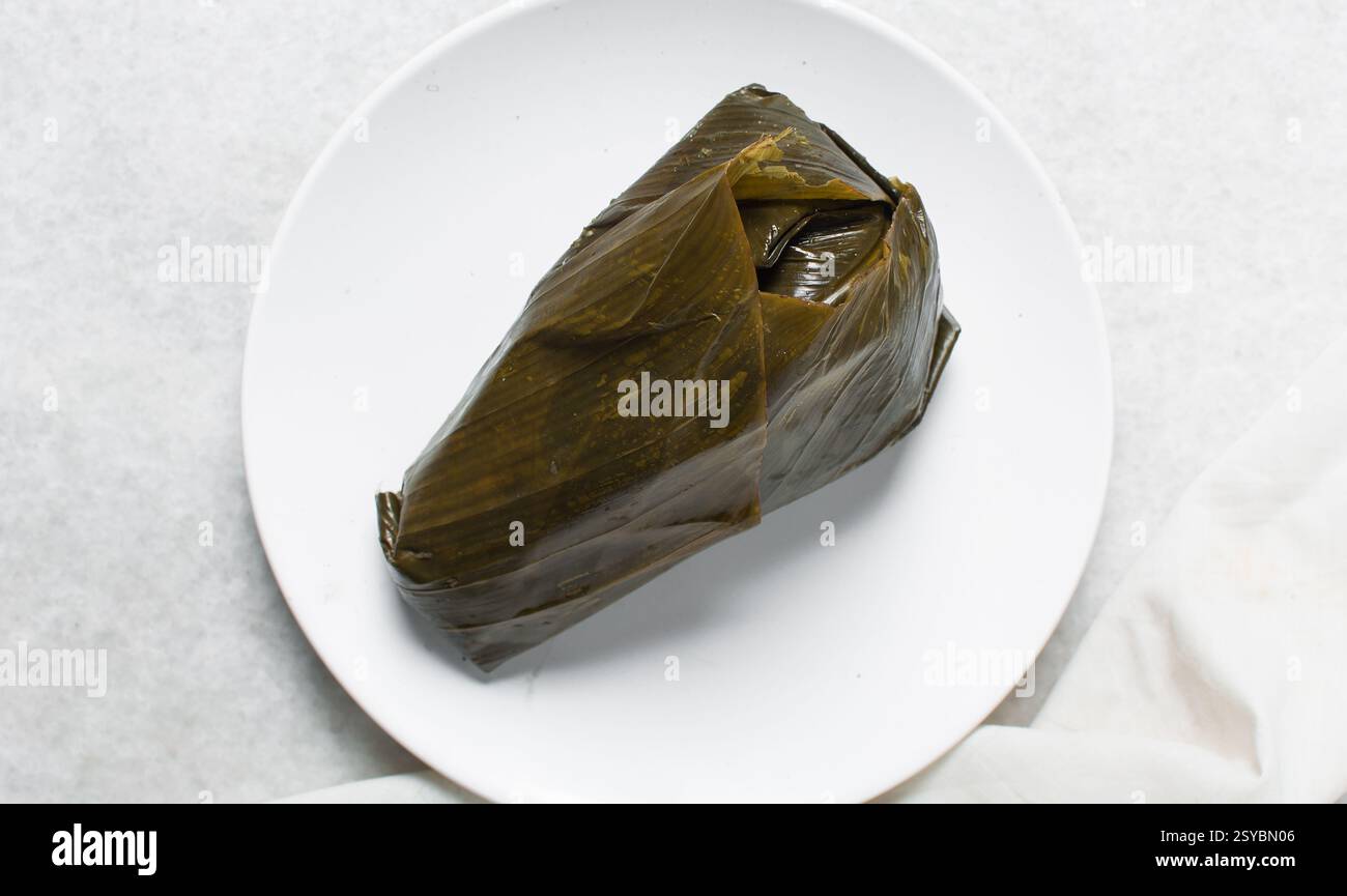 Overhead of moi moi in leaf on a plate, top view of nigerian bean ...