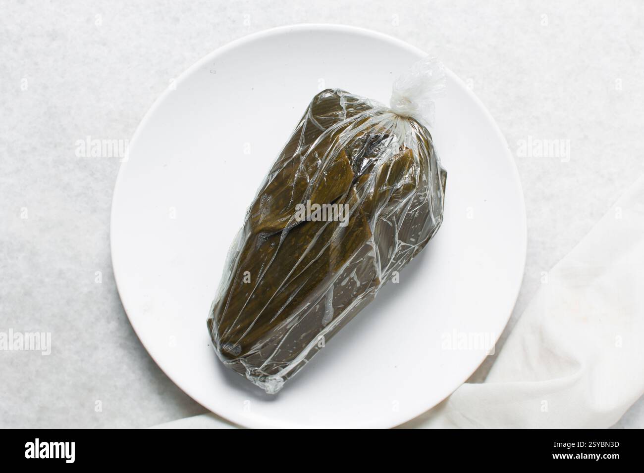 Overhead of moi moi in leaf on a plate, top view of nigerian bean ...