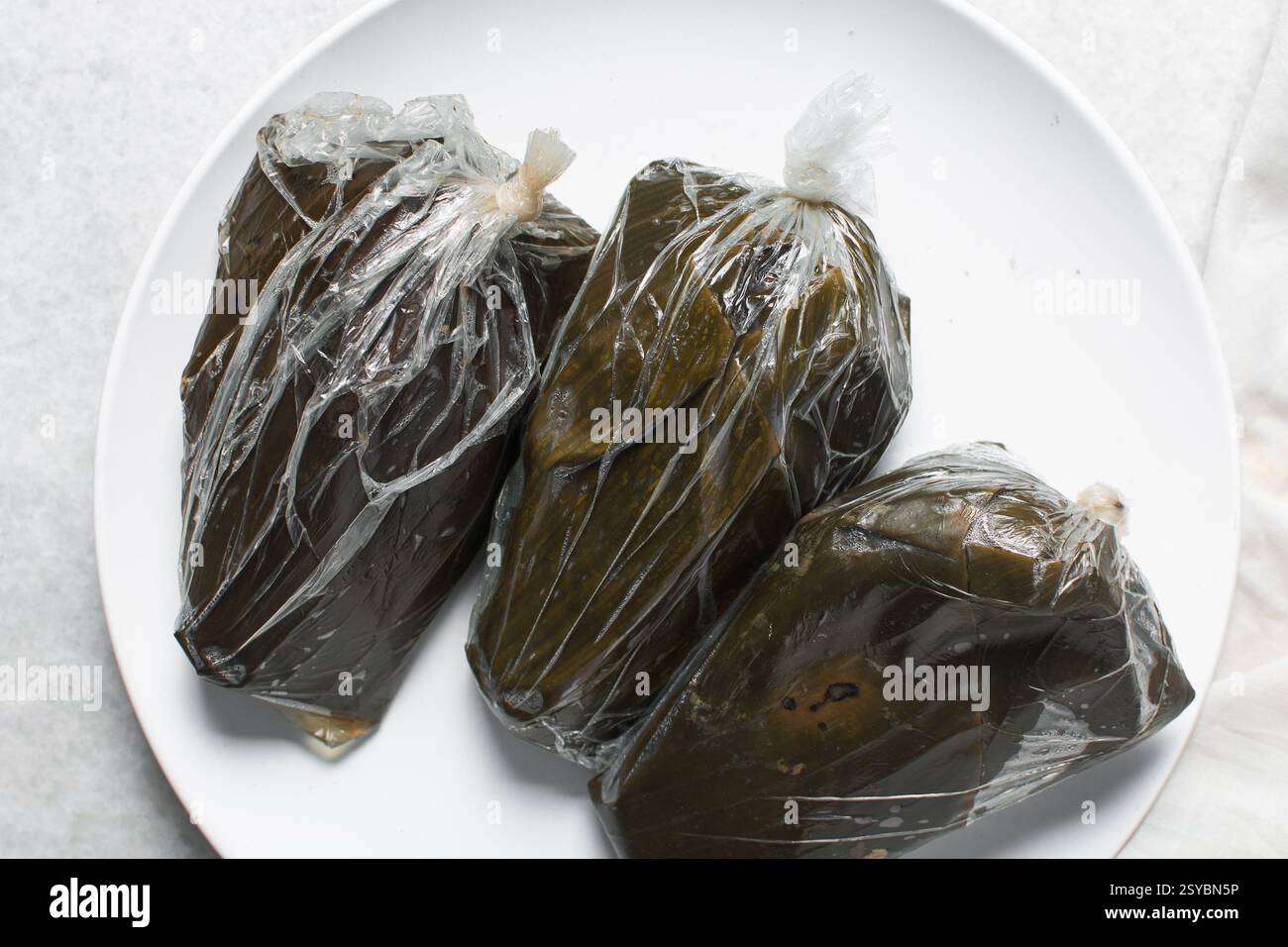 Overhead of moi moi in leaf on a plate, top view of nigerian bean ...