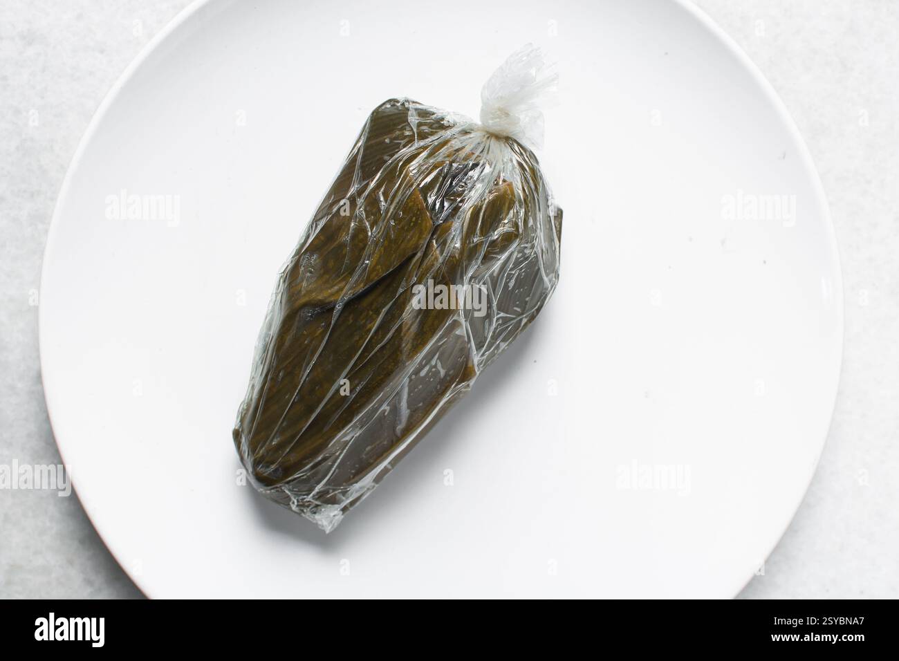 Overhead of moi moi in leaf on a plate, top view of nigerian bean ...