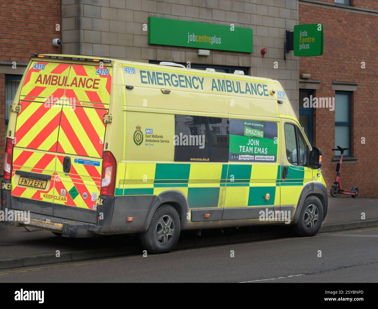 NHS emergency ambulance outside the Jobcentreplus at Kettering, England ...