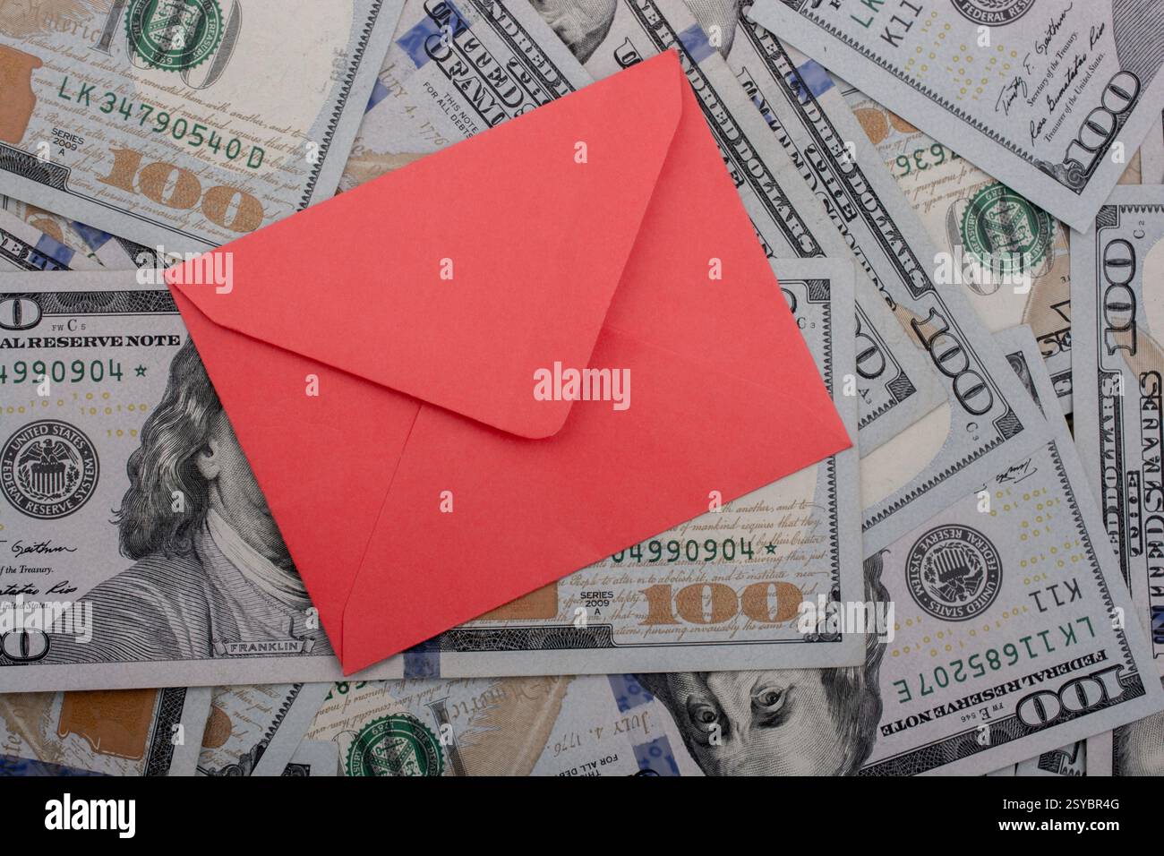 Little red envelope is placed on spread US dollar Banknotes Stock Photo ...