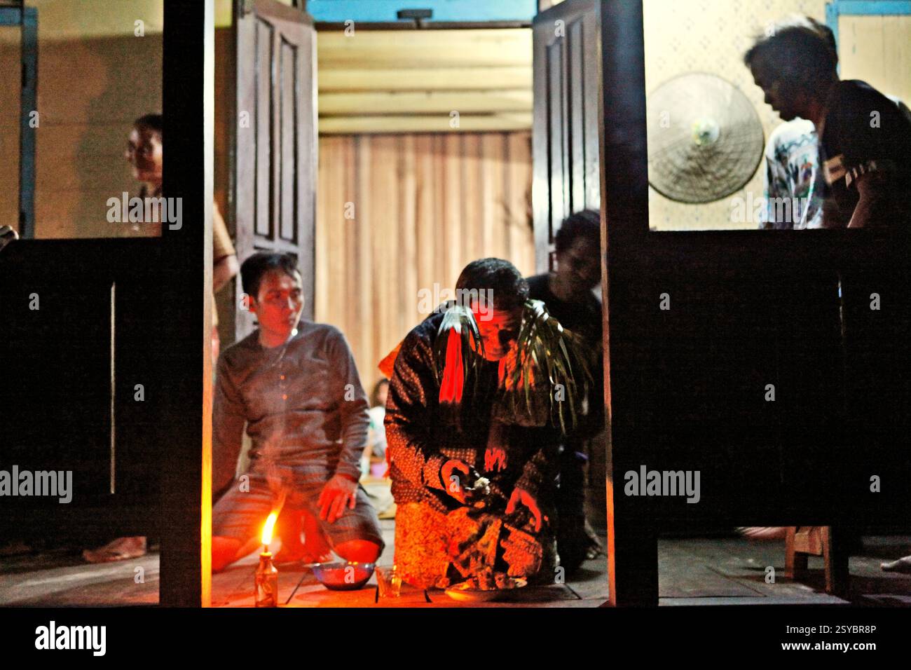 A witch doctor conducting a ritual on the porch of Dayak Iban's ...