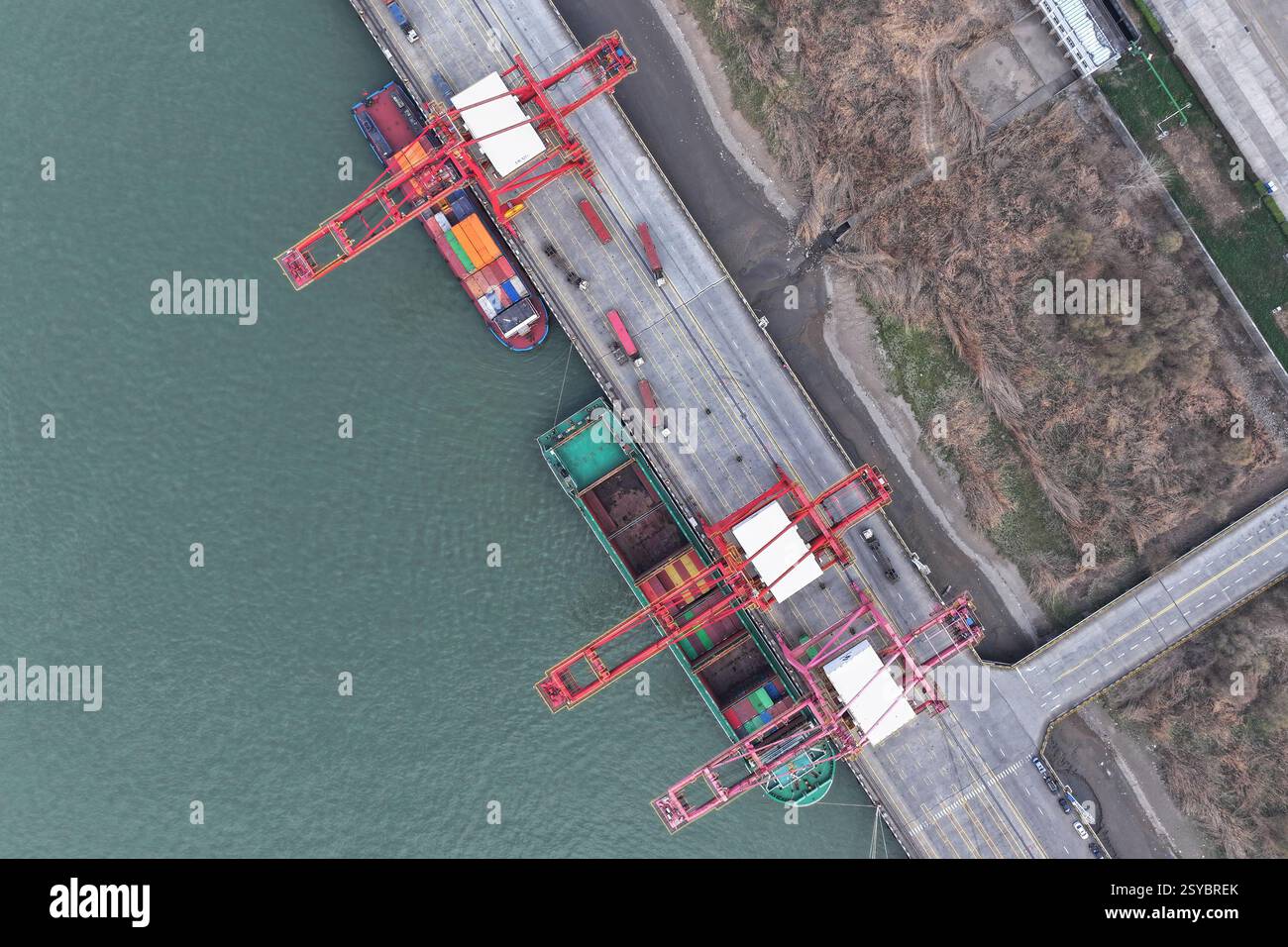 Cargo ships load and unload containers at the Longtan Container ...