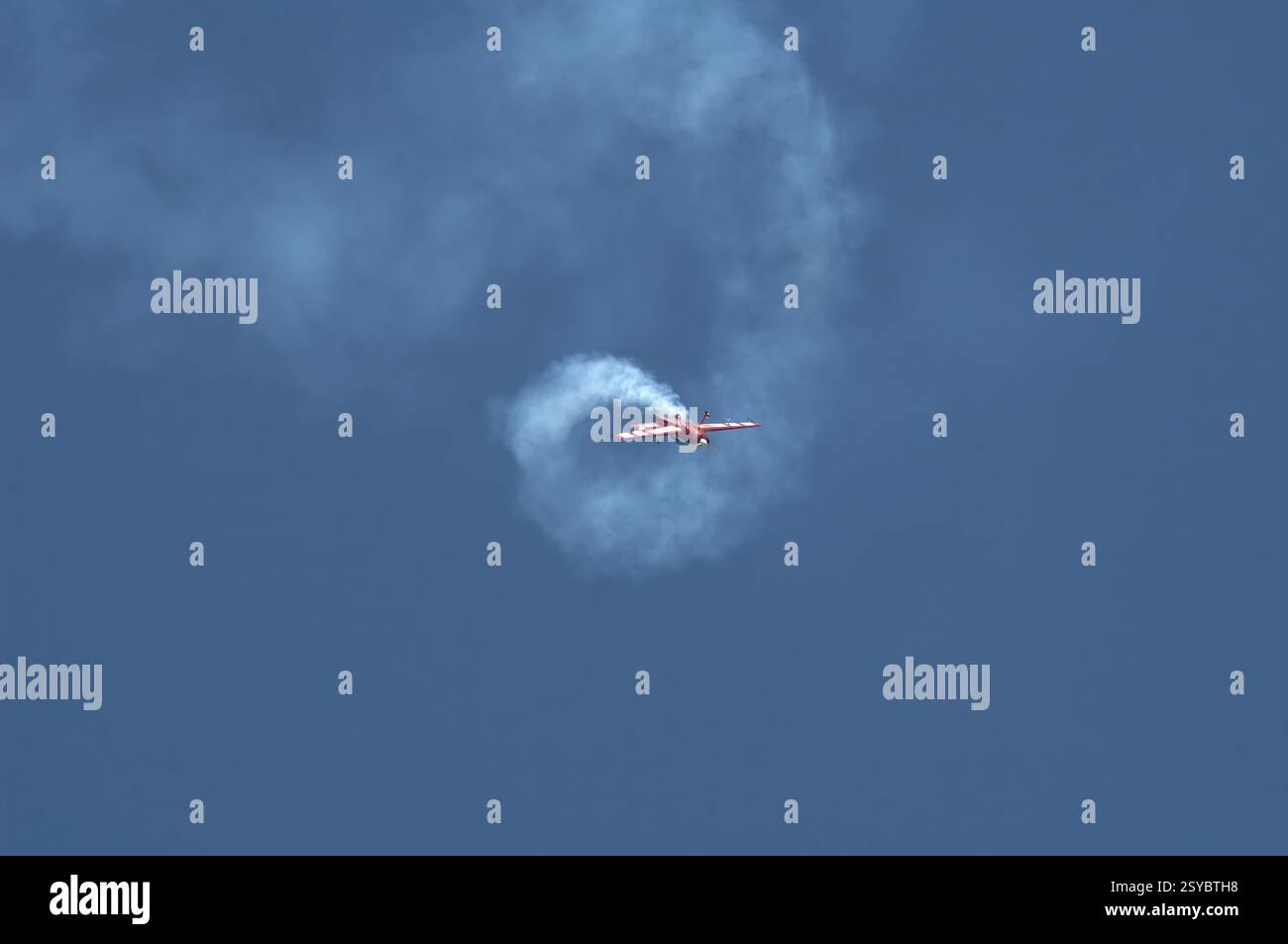 Piper plane leaves a smoke trail in the sky while performing ...