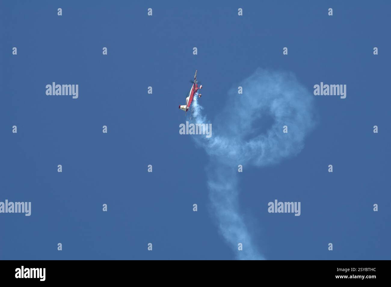 Piper plane leaves a smoke trail in the sky while performing ...