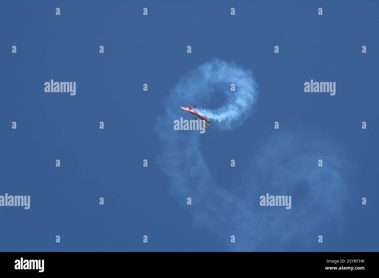 Piper plane leaves a smoke trail in the sky while performing ...