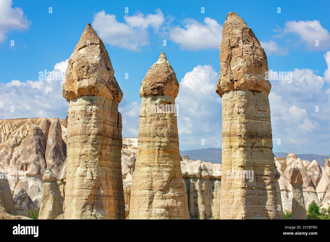 Three striking stone pillars stand tall against a backdrop of soft ...