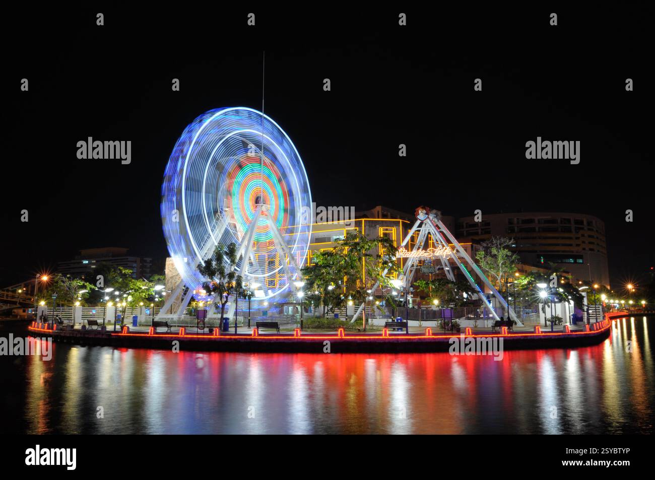 A night view of a merry go round at Malacca River Pirate Park, Malaysia ...