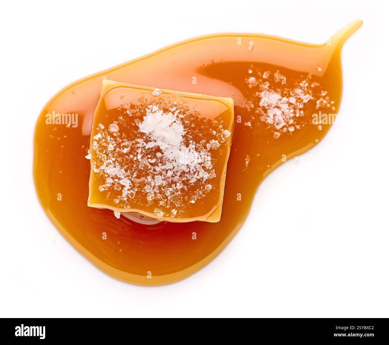salted caramel candy in melted caramel sauce isolated on white ...
