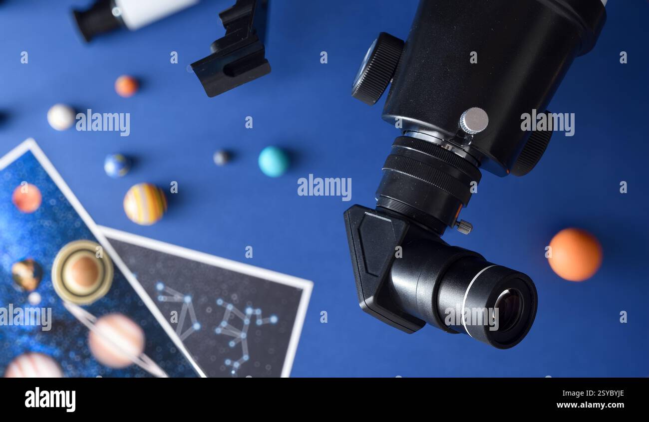 Detail of eyepiece mounted on a telescope and blue background with ...