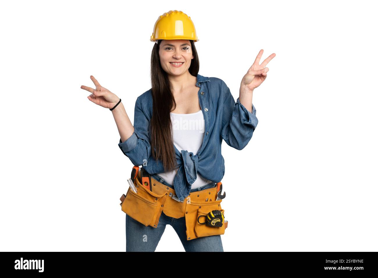 A smiling female construction worker wearing a yellow hard hat and a ...