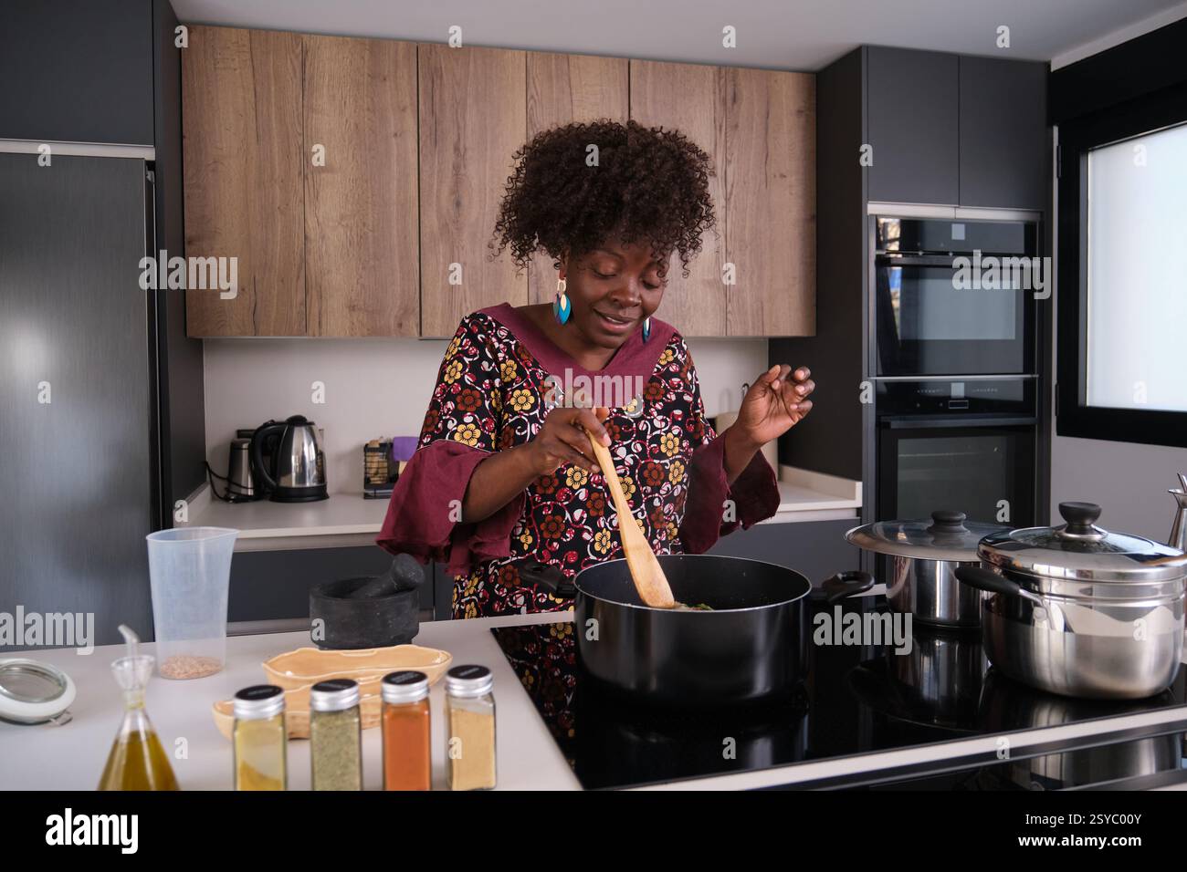 Woman cooking traditional African okra soup with spinach Stock Photo ...