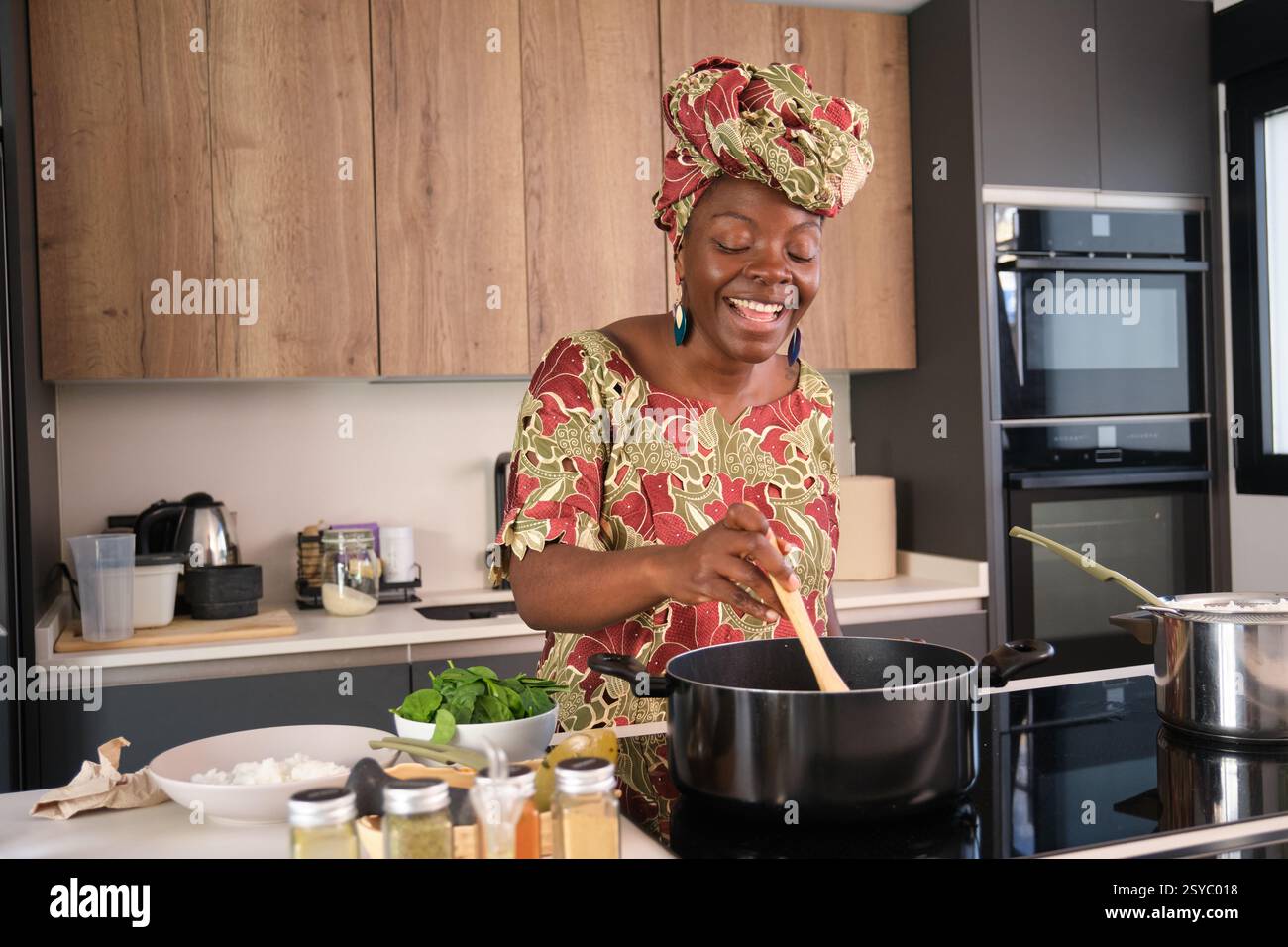 Happy African woman cooking traditional Okro Soup Stock Photo - Alamy