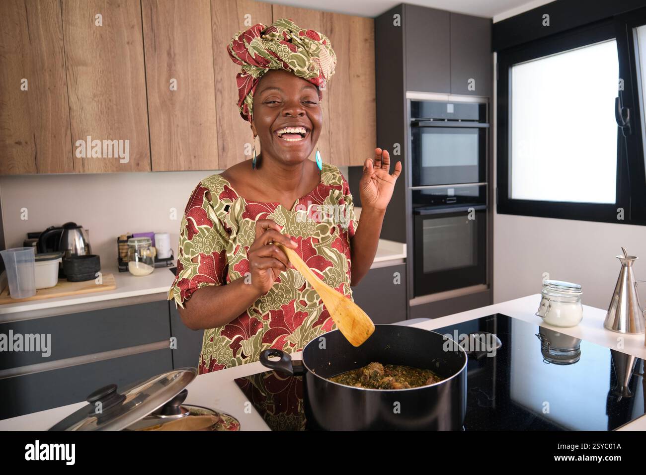 African woman cooking traditional Okra Soup in modern kitchen Stock ...