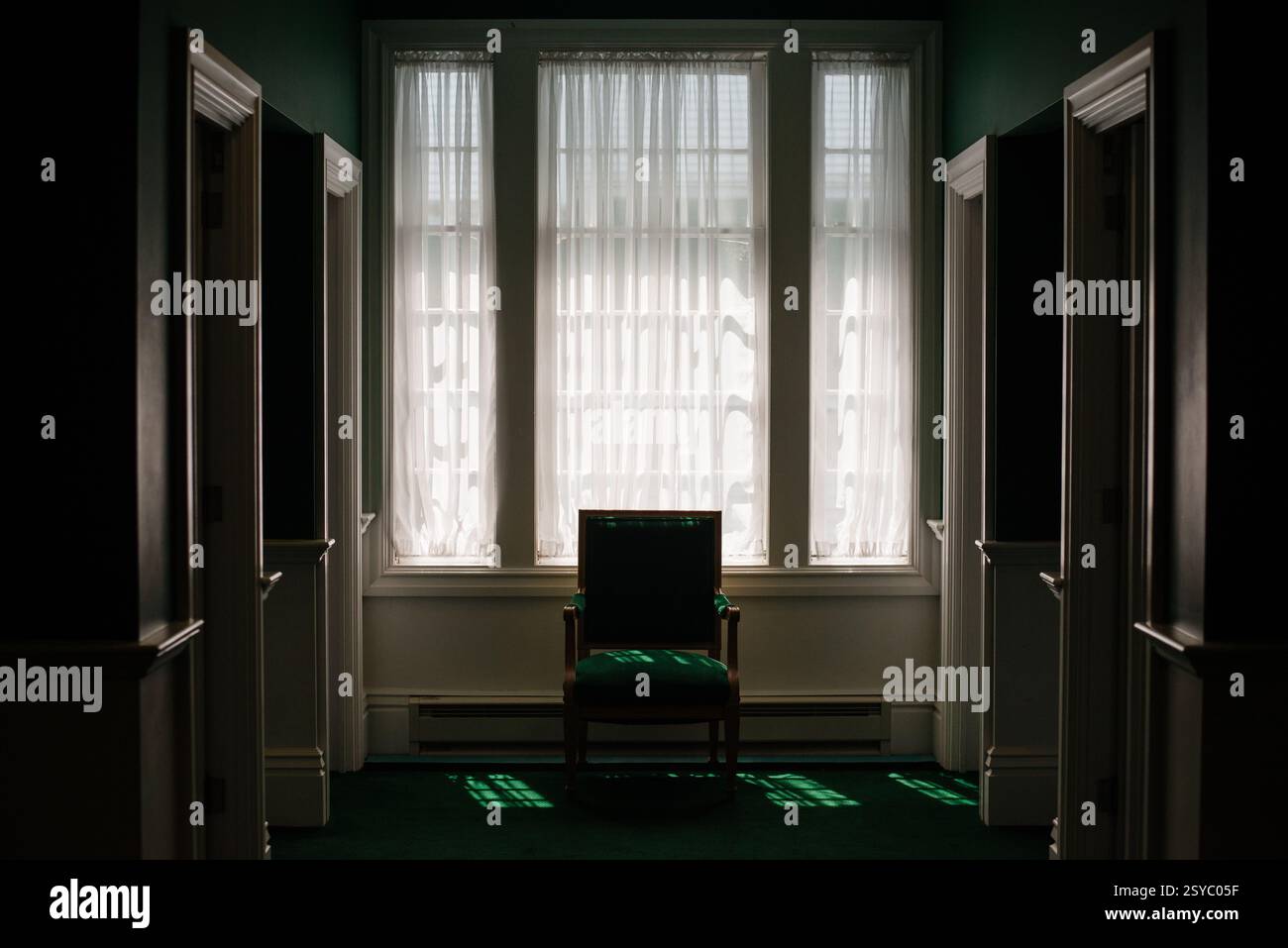A Single Green Chair Against Grand Windows Stock Photo - Alamy