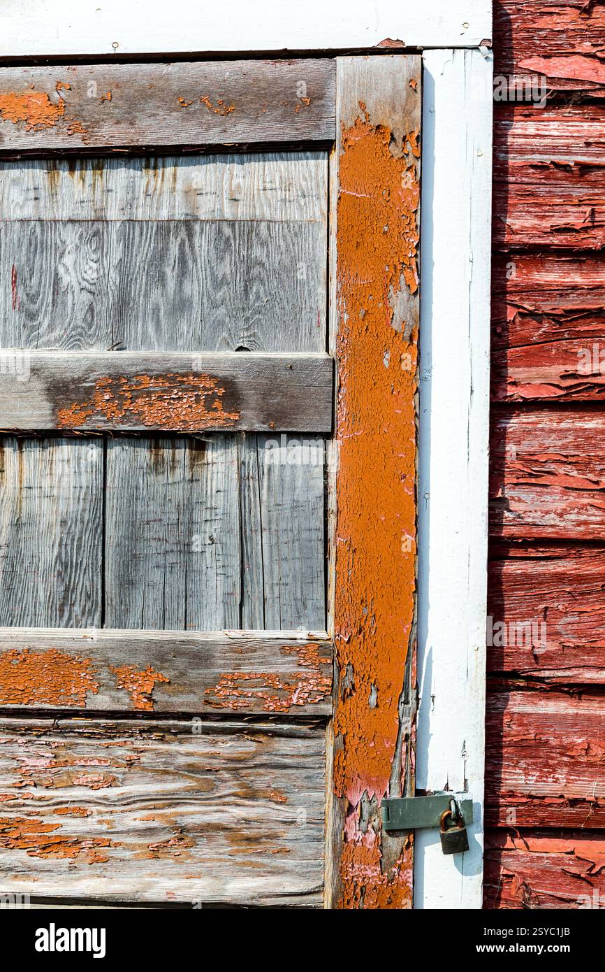 Wooden door with a lock on it. The door is painted red and white. The ...