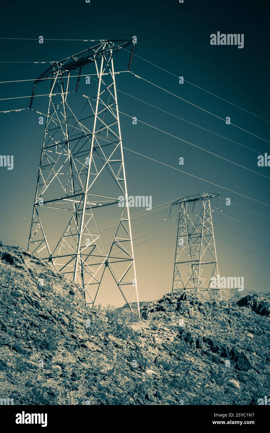 Two tall power lines are on a hill. The sky is blue Stock Photo - Alamy