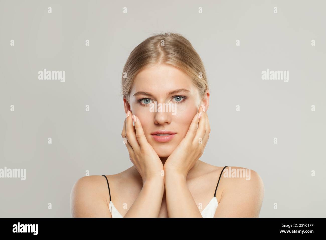 Lovely young blond female model with clear skin, soft make-up and ...