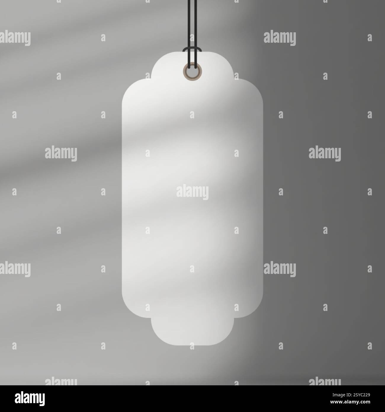 Blank hanging tag with a decorative shape, suspended against a neutral ...