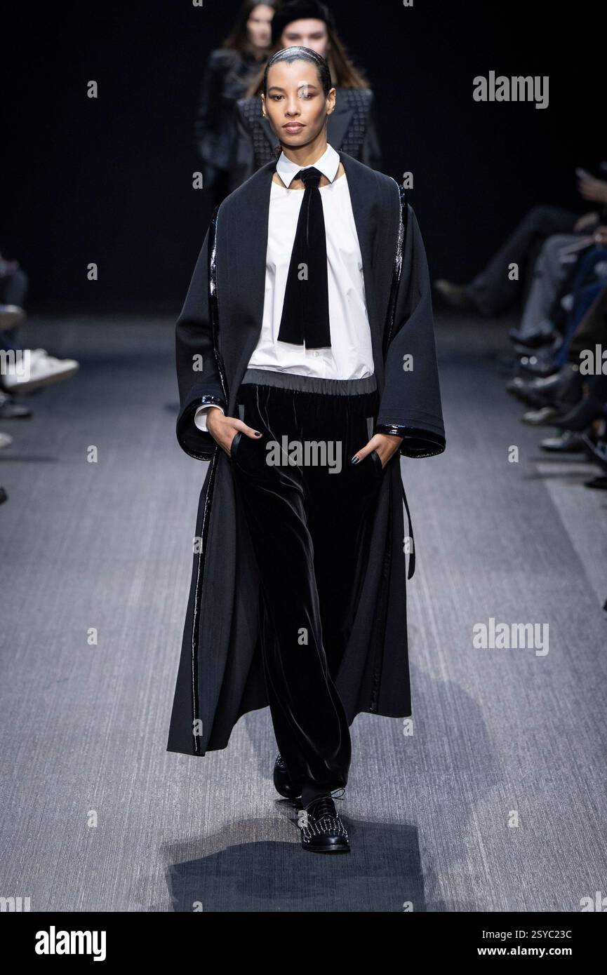 Milan, Italy. 27th Feb, 2025. A model walks on the runway during the ...