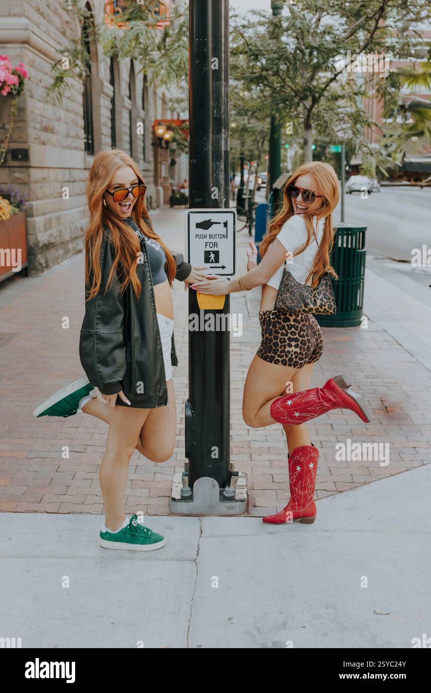 Trendy young women laugh and pose in a vibrant downtown setting Stock ...