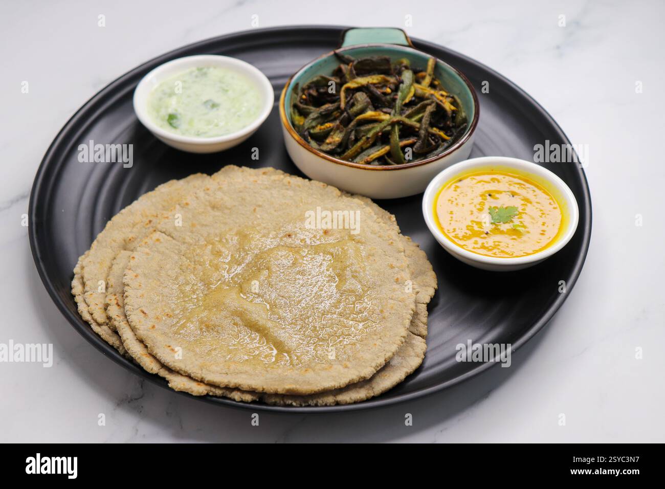 Roti and Sabzi. Indian vegetarian Thali includes bhindi fry, yellow ...