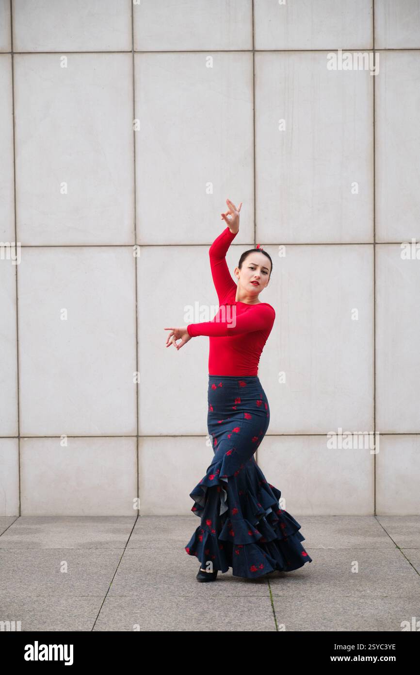 Flamenco dancer performing with elegance and passion against a wall ...