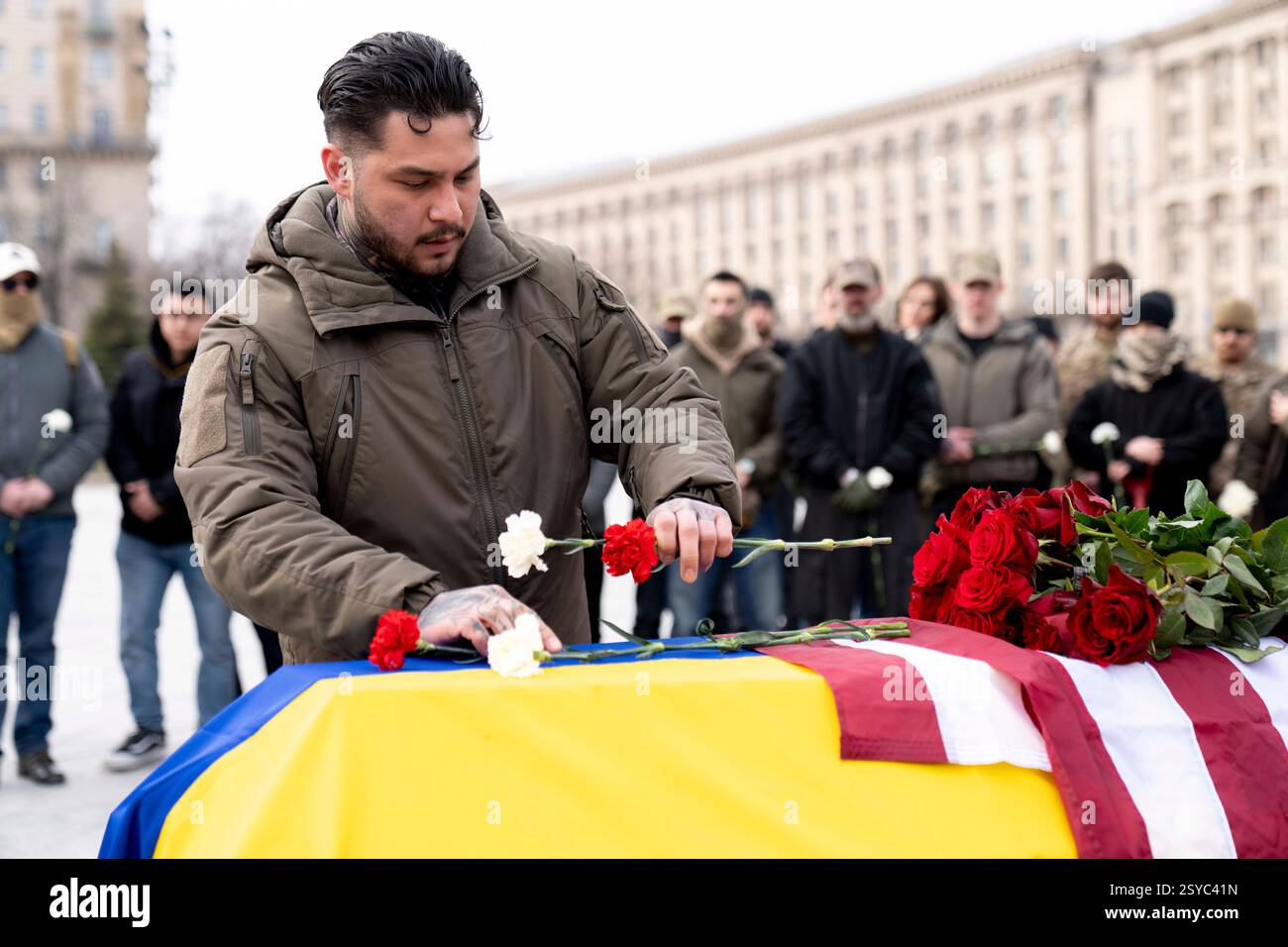 Friends and fellow soldiers lay flowers on coffin at Memorial service ...