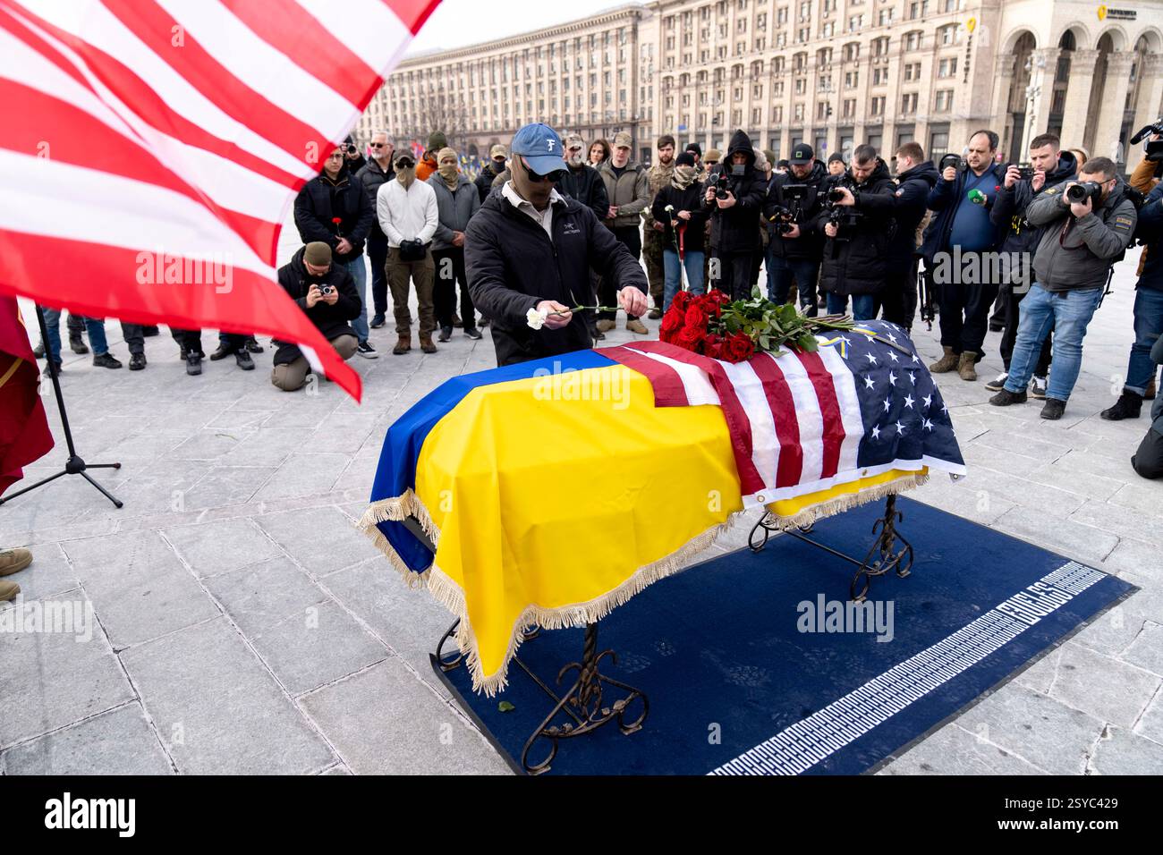 Friends and fellow soldiers lay flowers on coffin at Memorial service ...