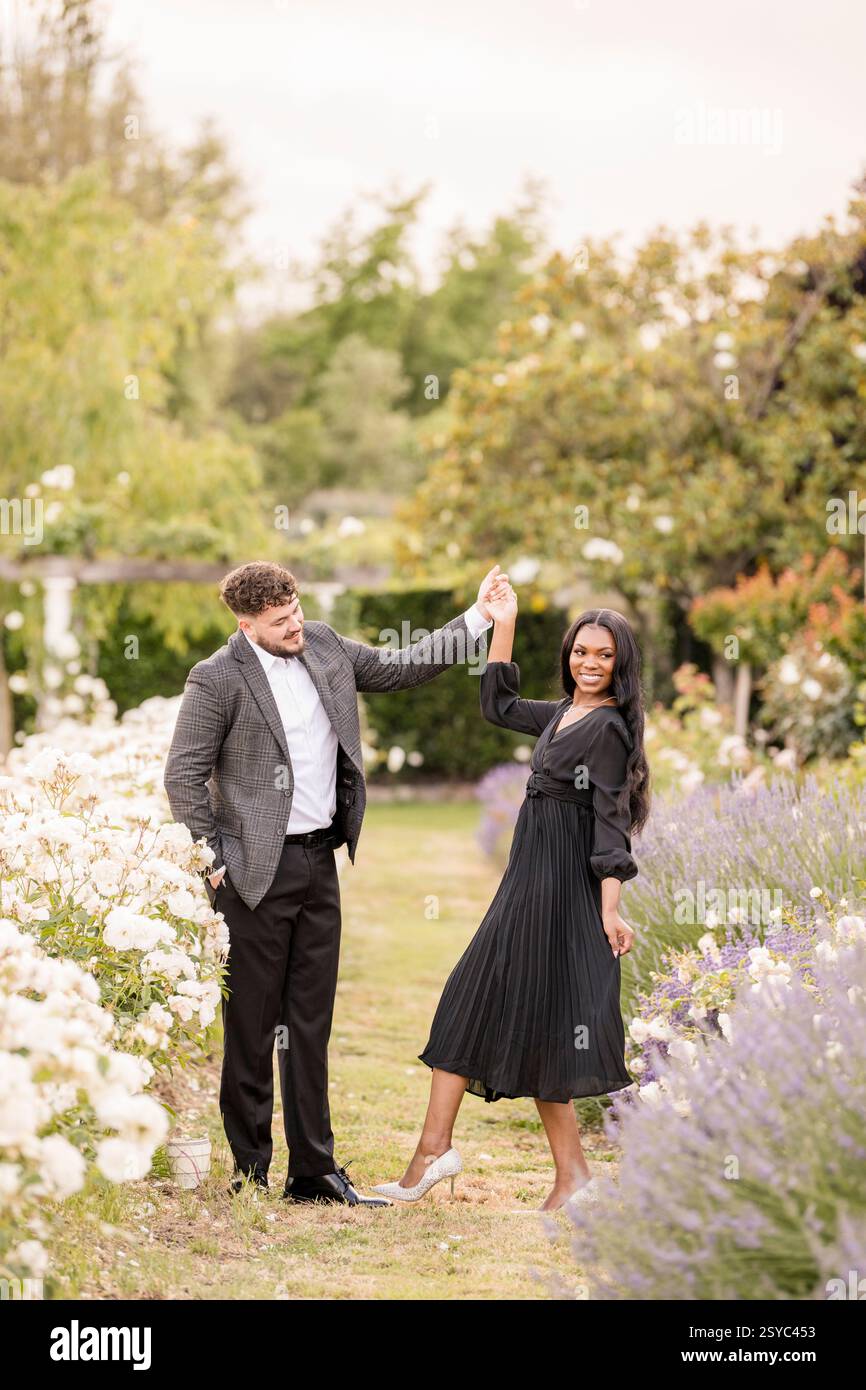 Elegant couple dancing together in a romantic flower garden Stock Photo ...
